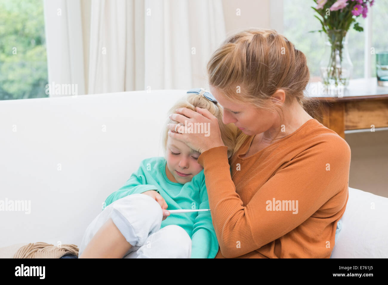 Mother taking the temperature of sick daughter Stock Photo - Alamy