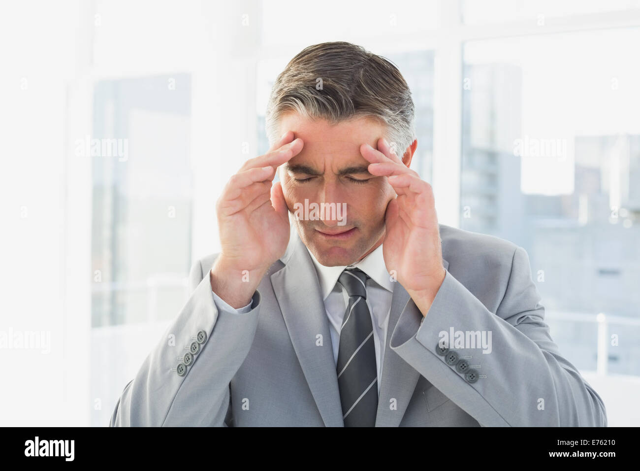 Businessman suffering from a headache Stock Photo - Alamy