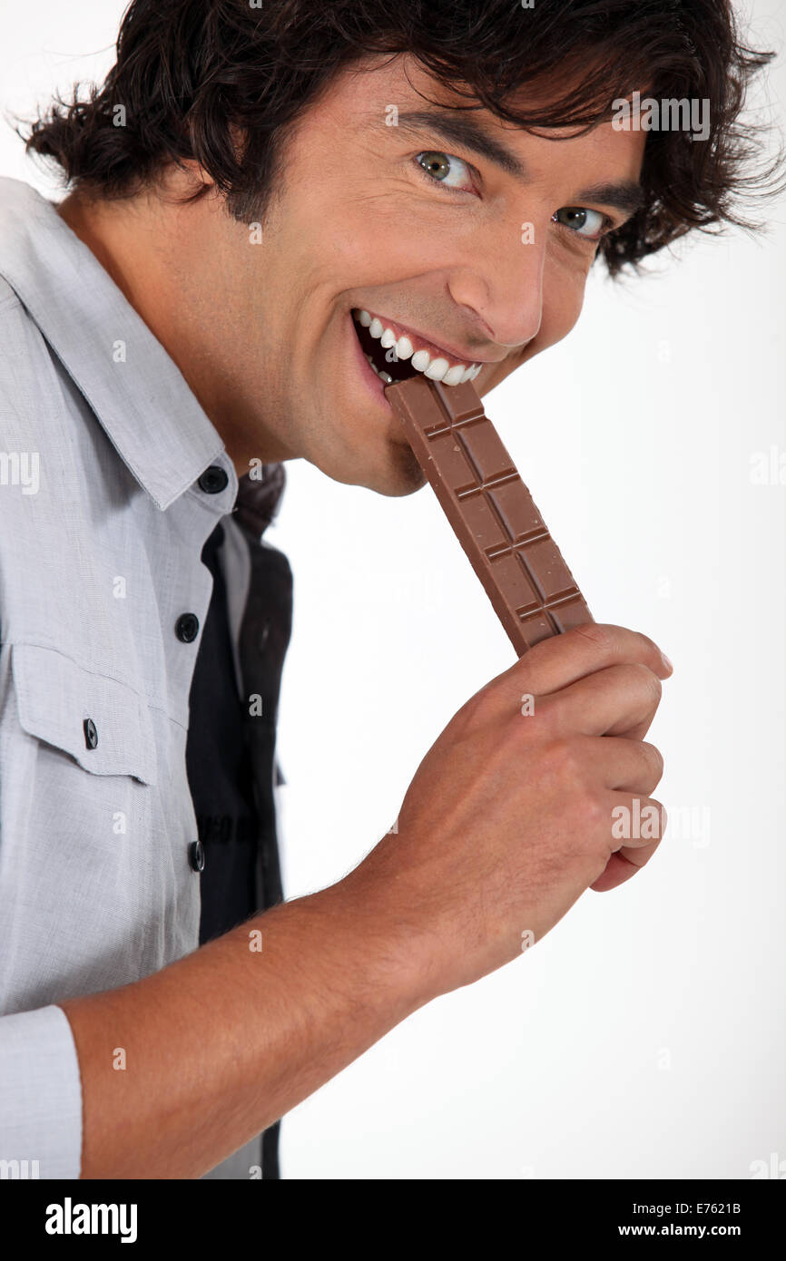 man eating chocolate Stock Photo - Alamy