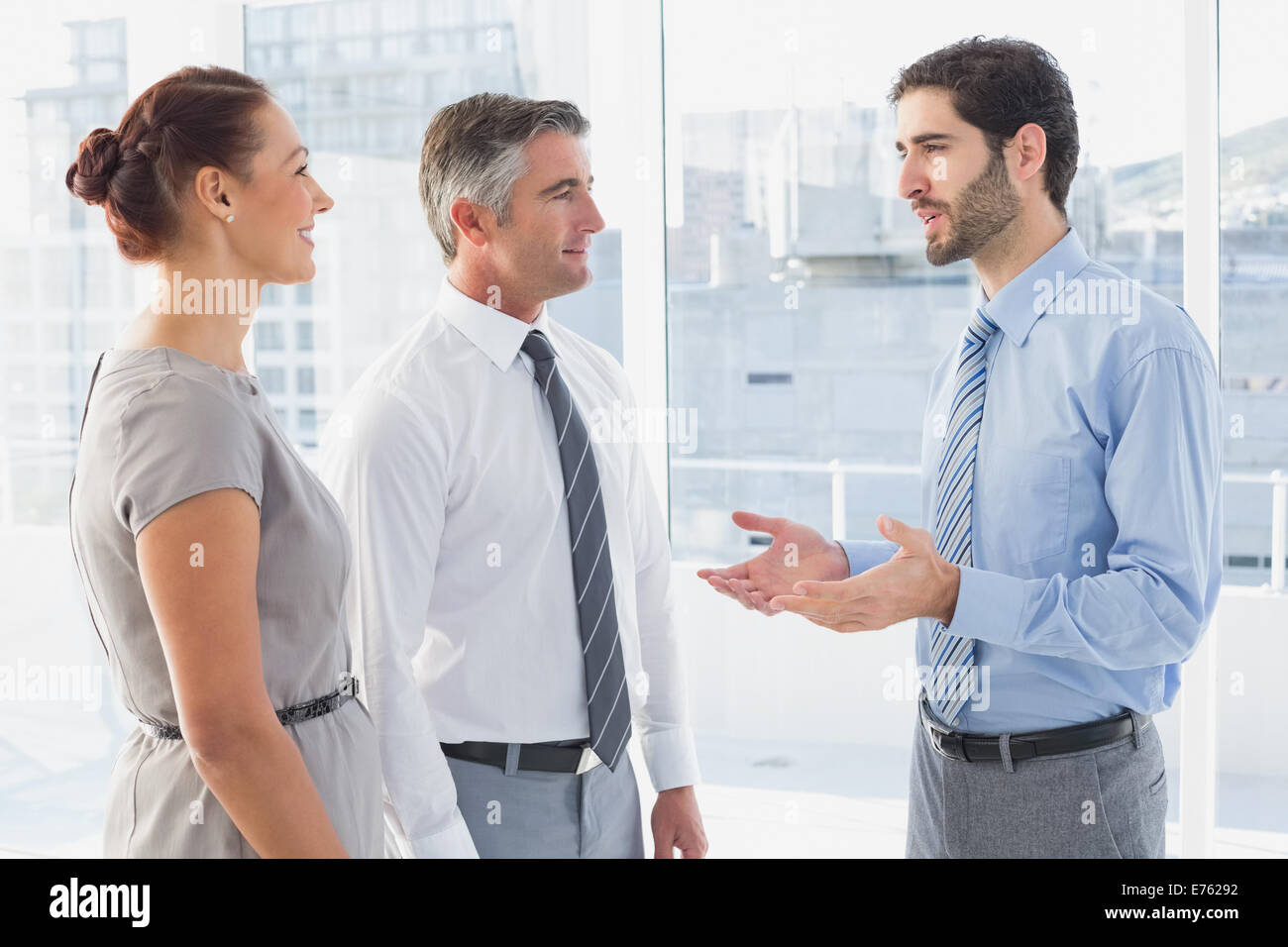 Businessman chatting with co-worker Stock Photo - Alamy