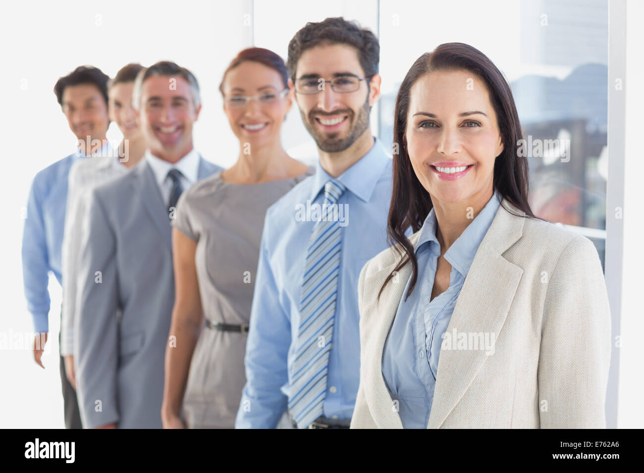 Smiling employee's in a line Stock Photo - Alamy