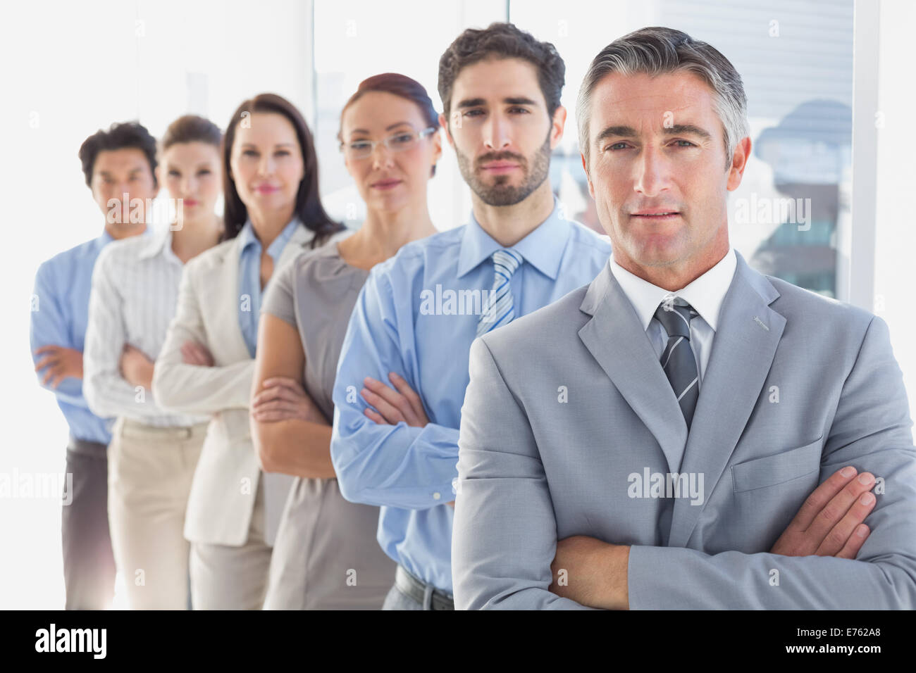 Smiling employee's in a line Stock Photo - Alamy