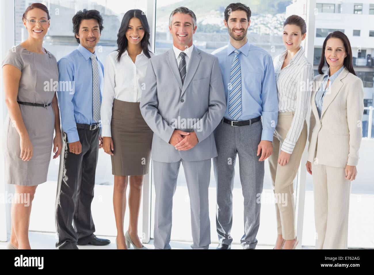 Happy workers standing all together Stock Photo - Alamy