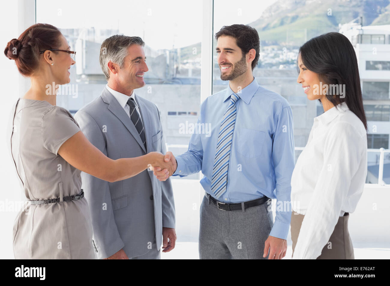 Happy two woman employees shaking hi-res stock photography and images - Alamy