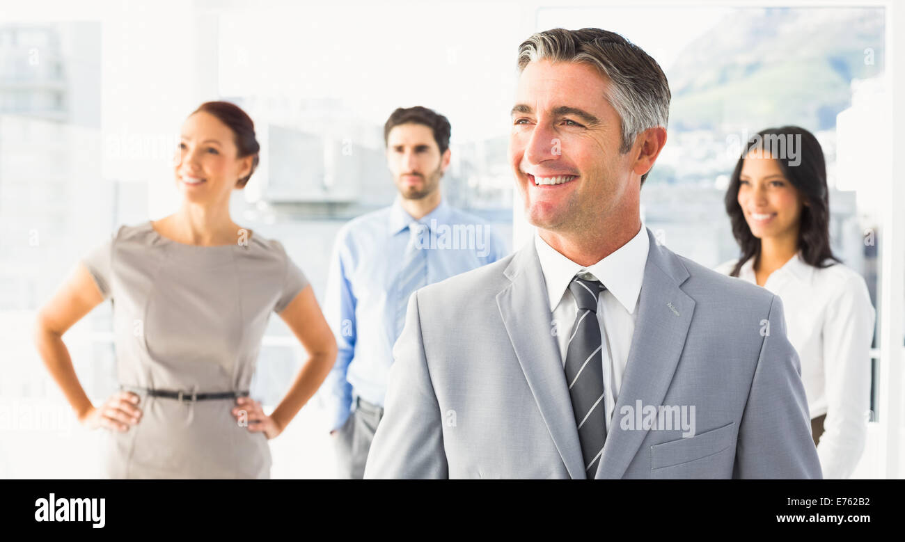 Smiling businessman and his co-workers Stock Photo - Alamy