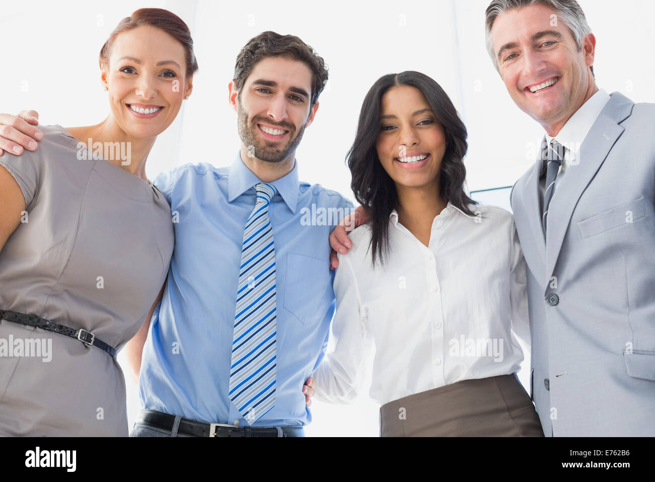 Workers smiling while standing together Stock Photo - Alamy