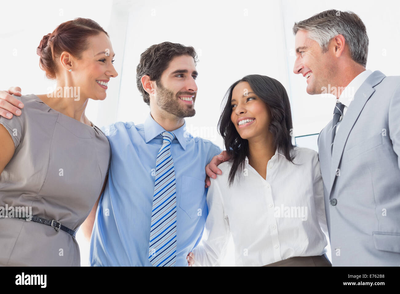Smiling employee's standing all together Stock Photo - Alamy
