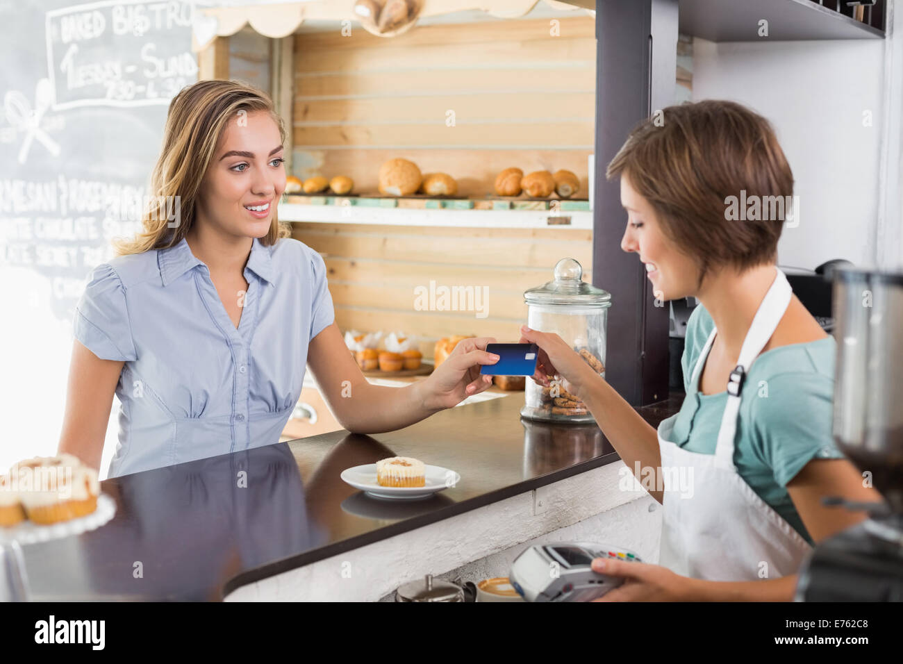 Barista serving a happy customer Stock Photo - Alamy