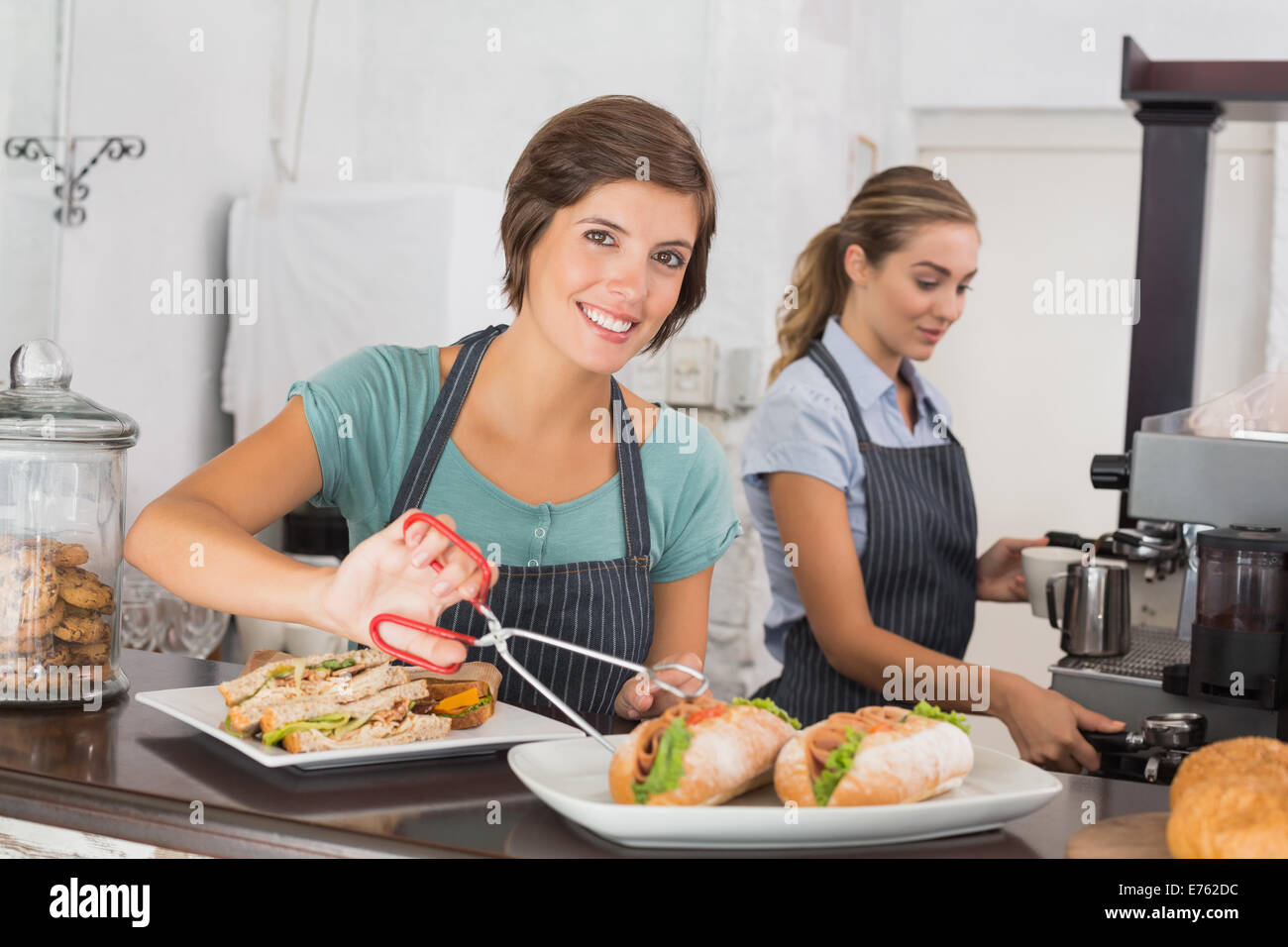 Pretty waitresses working with a smile Stock Photo - Alamy