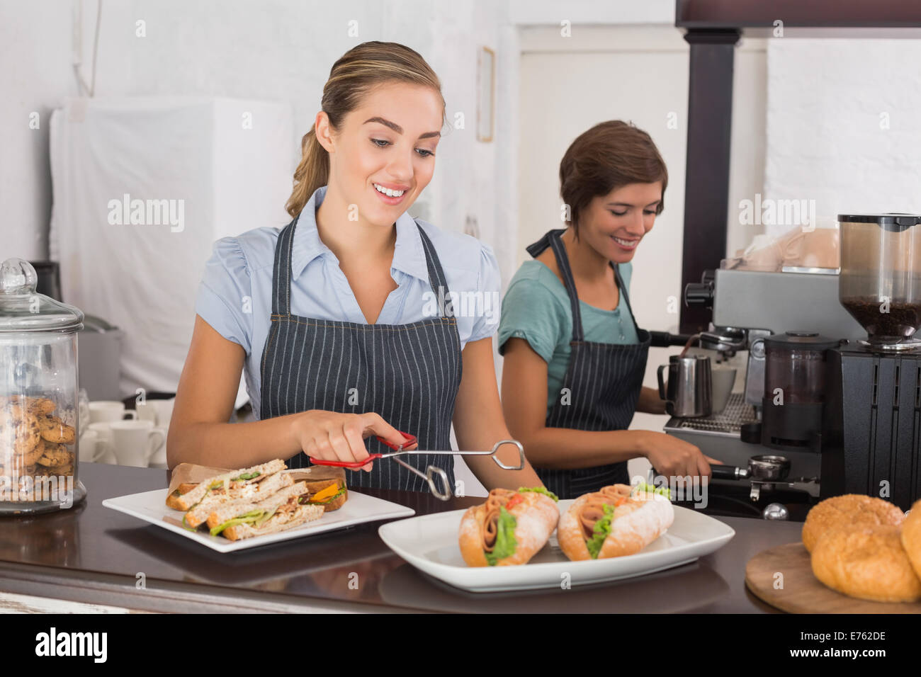 Pretty waitresses working with a smile Stock Photo - Alamy