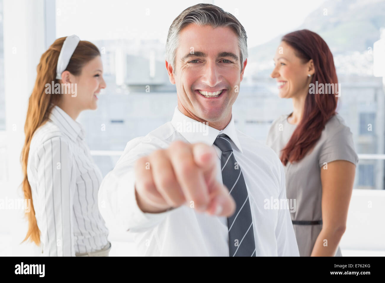 Smiling businessman pointing at camera Stock Photo - Alamy