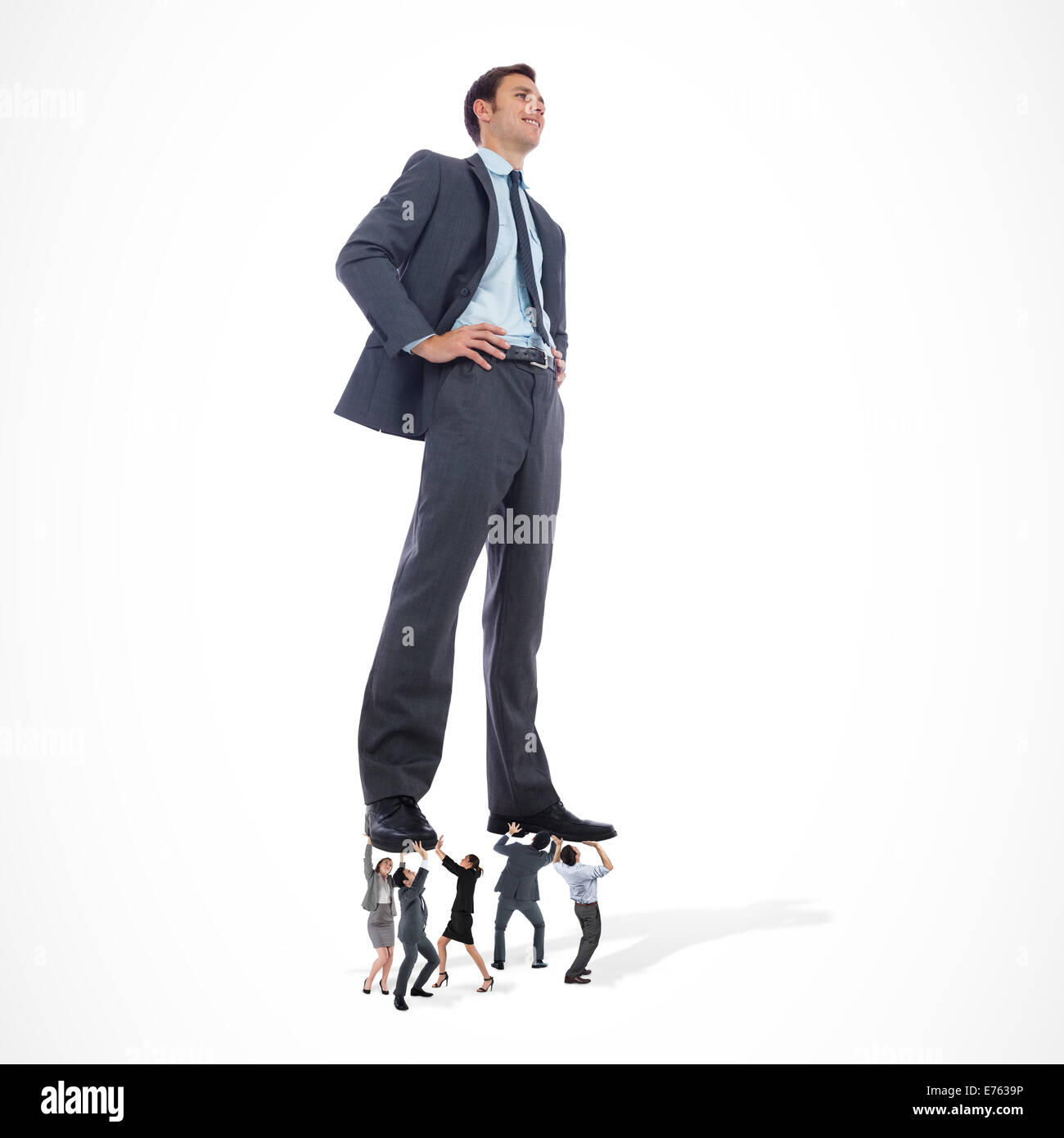 Composite image of business team supporting boss Stock Photo - Alamy
