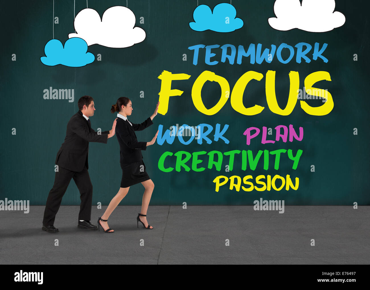 Composite image of business team standing and pushing Stock Photo - Alamy