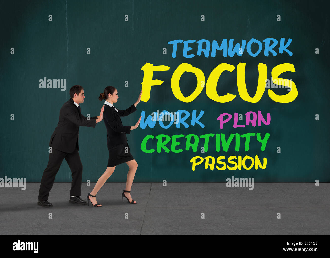 Composite image of business team standing and pushing Stock Photo - Alamy