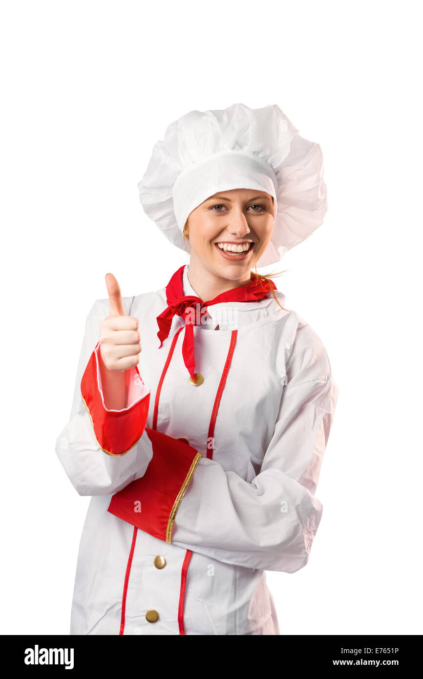 Pretty chef showing thumbs up Stock Photo - Alamy