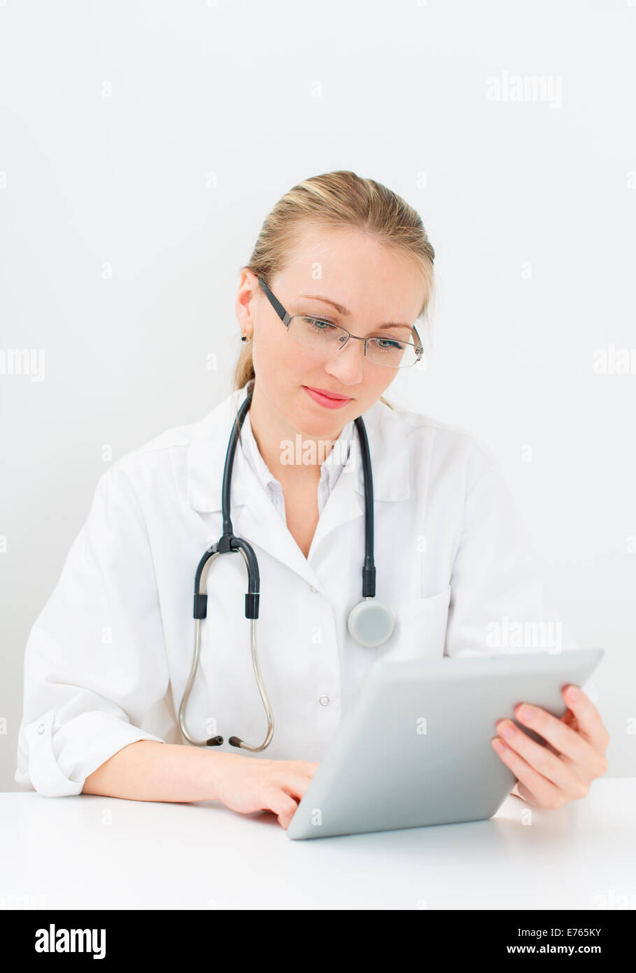 Medic reading on tablet pc hi-res stock photography and images - Alamy