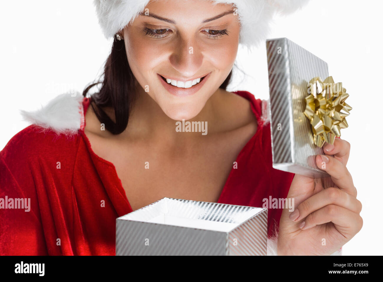Smiling woman opening christmas present Stock Photo - Alamy