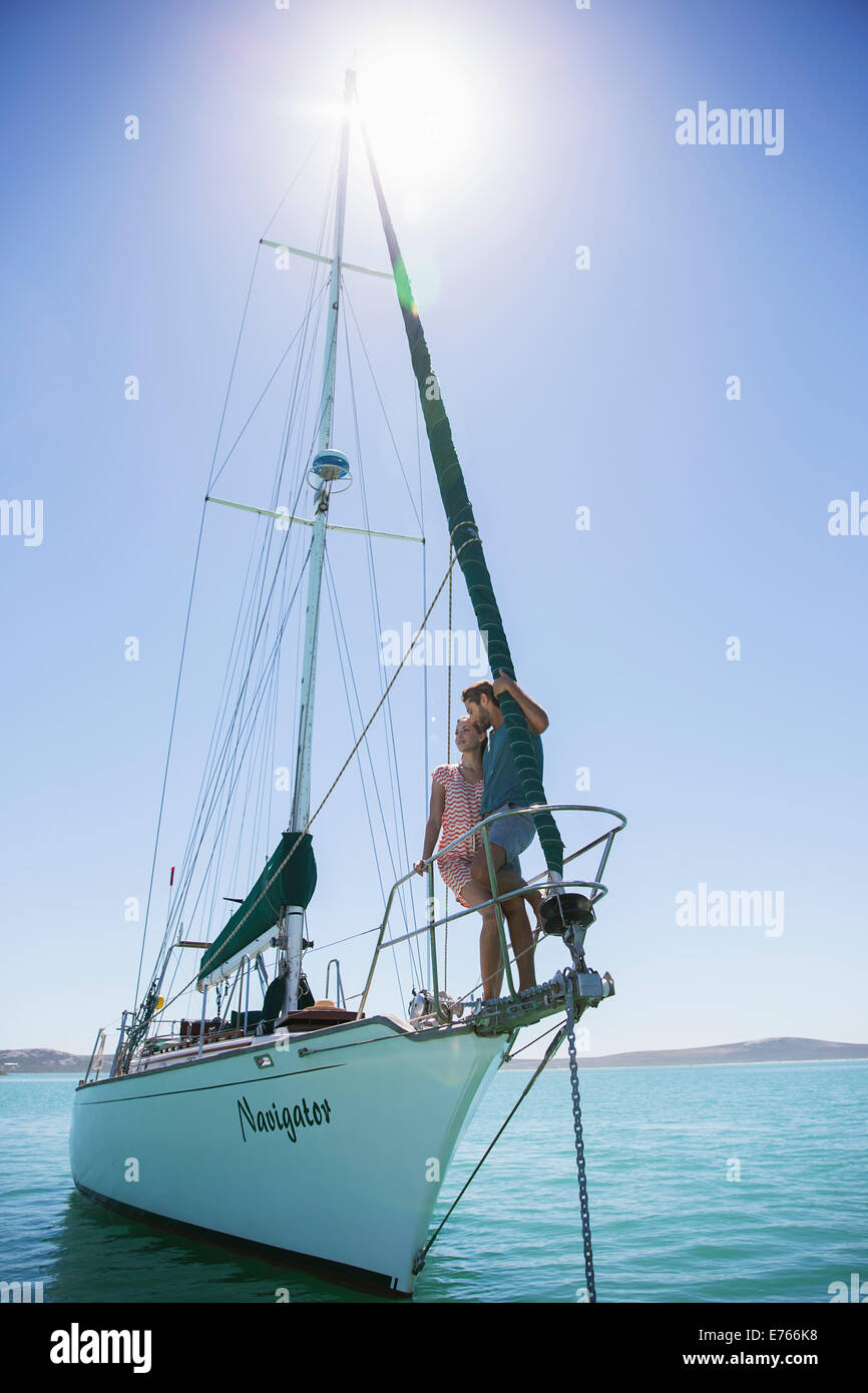 Couple standing on end of boat Stock Photo - Alamy