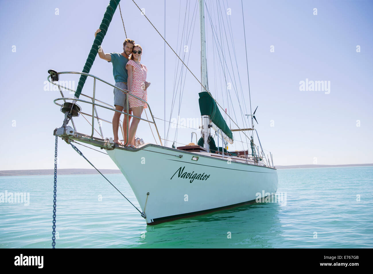 Couple standing on front of boat Stock Photo - Alamy