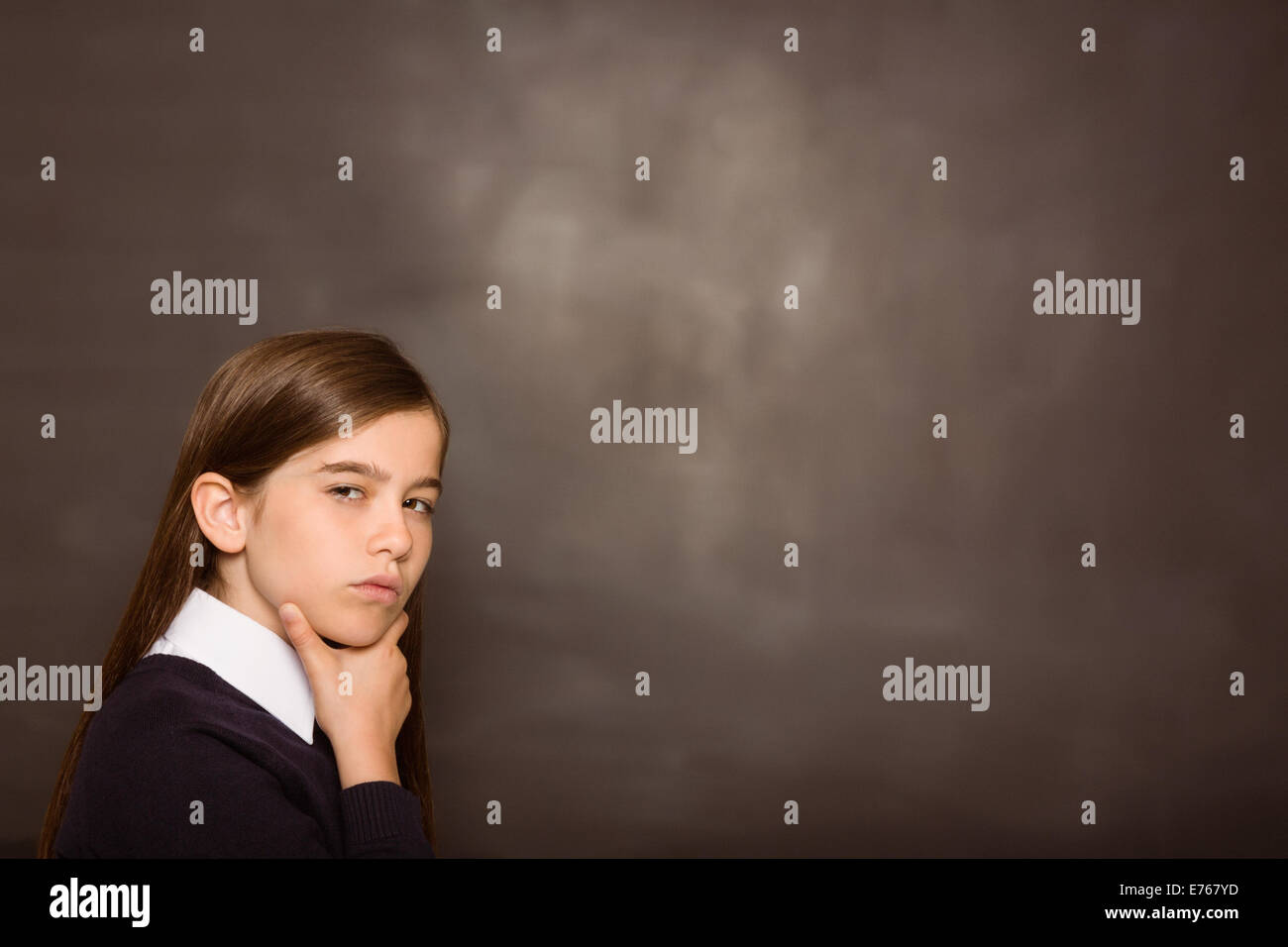 Thinking pupil looking at camera Stock Photo - Alamy