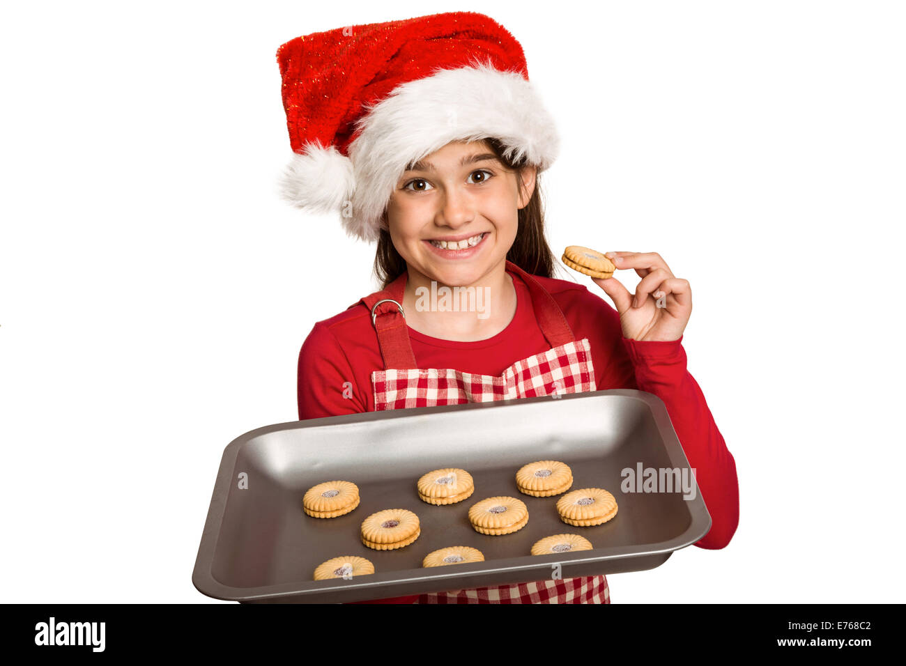 Festive little girl offering cookies Stock Photo - Alamy
