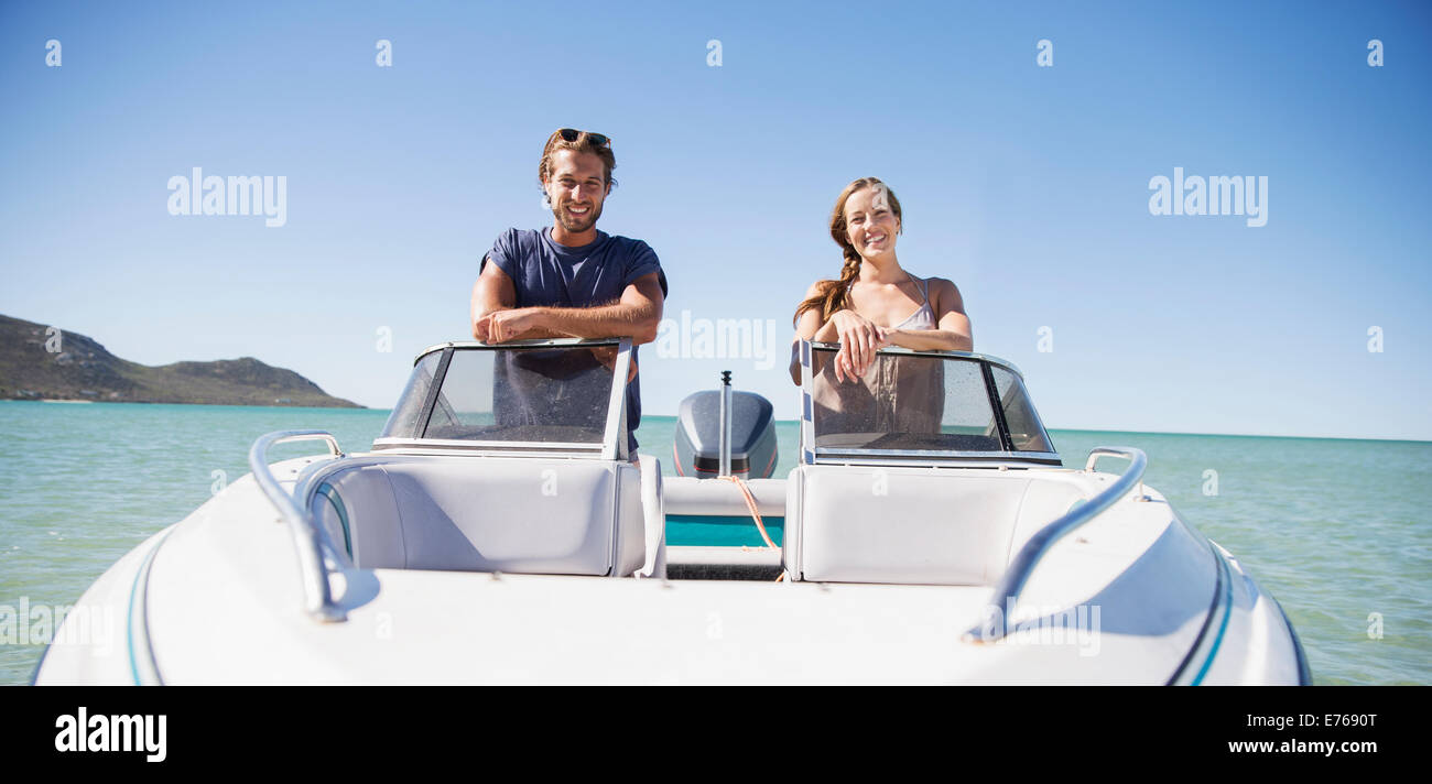Couple standing in boat on water Stock Photo - Alamy