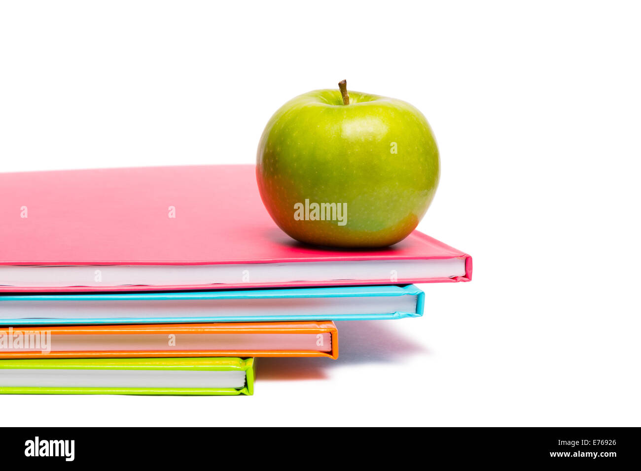 Green apple on notebooks Stock Photo - Alamy