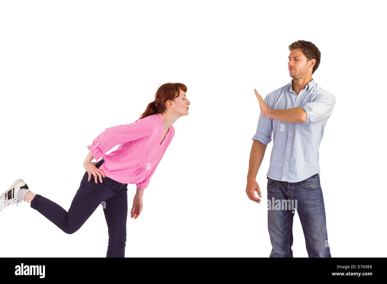 Man stopping woman from kissing Stock Photo - Alamy