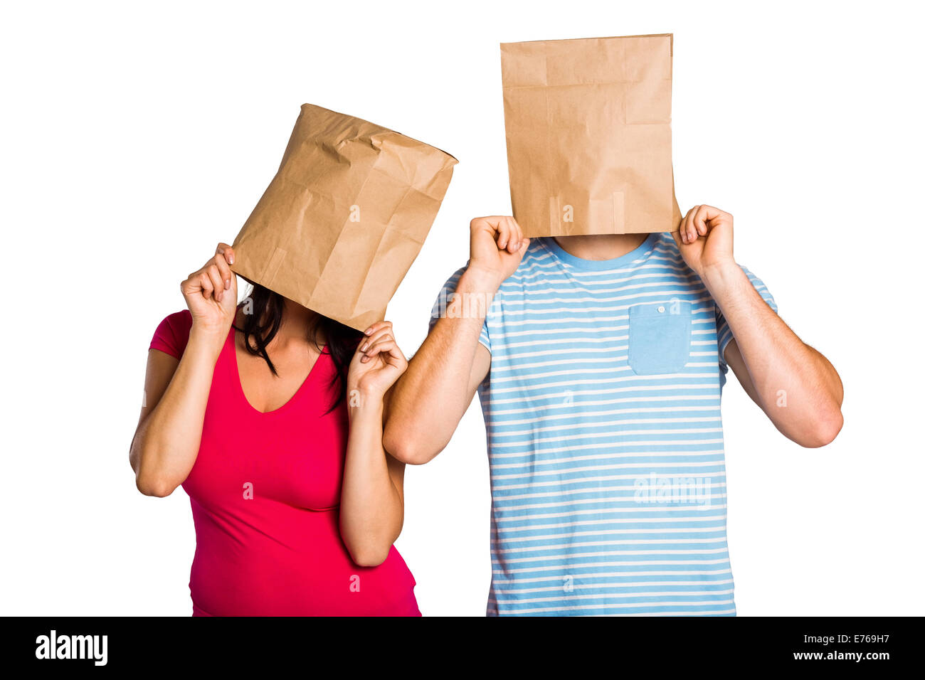 Young couple with bags over heads Stock Photo - Alamy