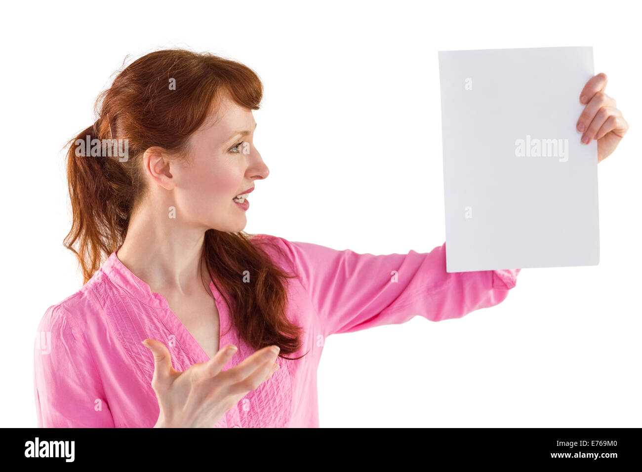 Surprised woman looking at paper Stock Photo - Alamy
