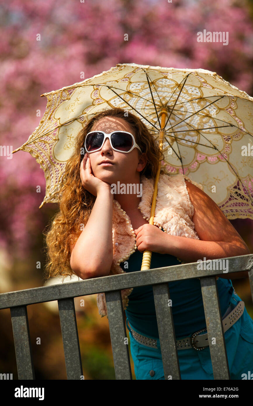Portrait of a 16 year old teen girl with sunglasses and a parasol ...