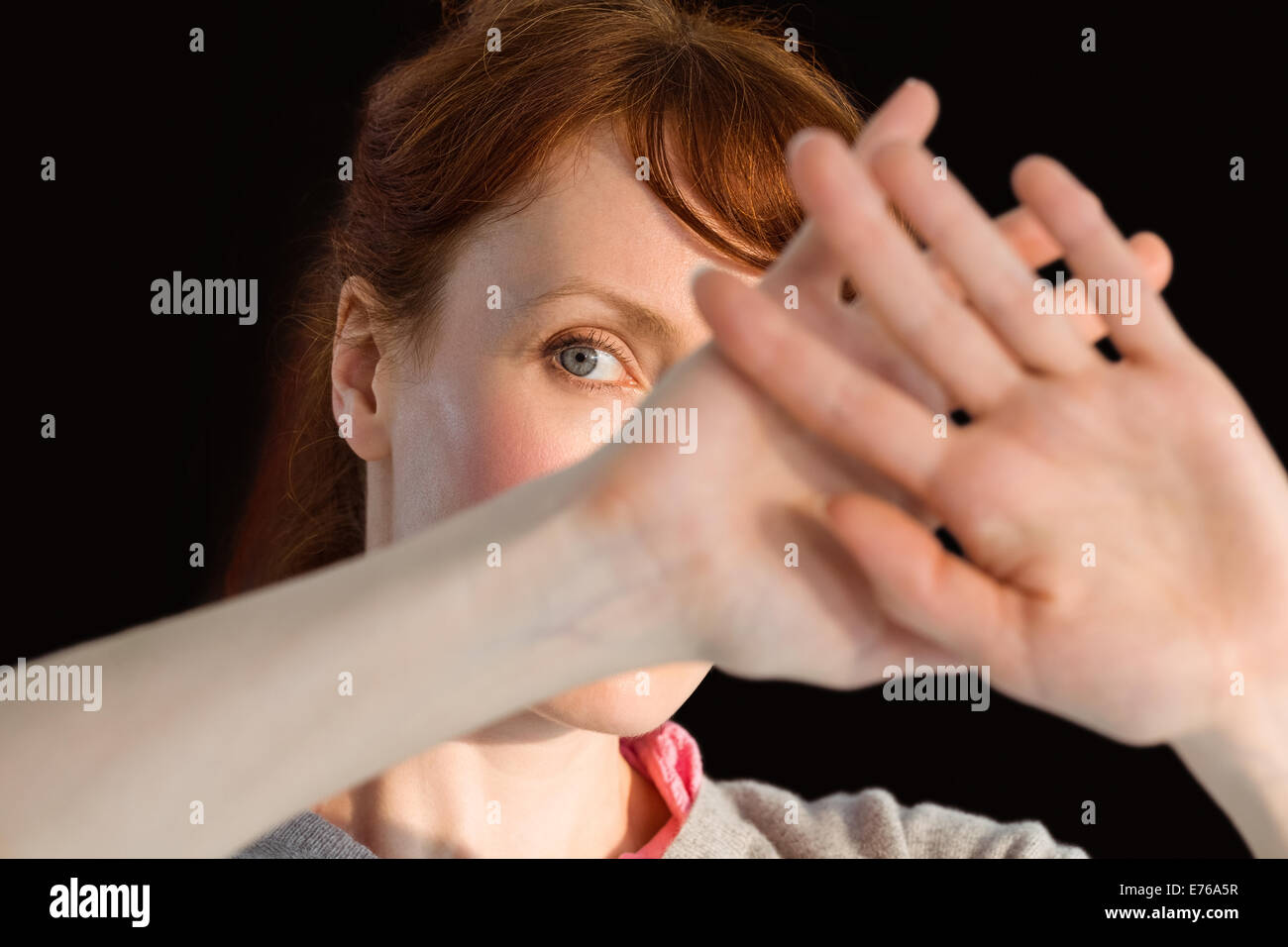 Scared woman covering her face Stock Photo - Alamy