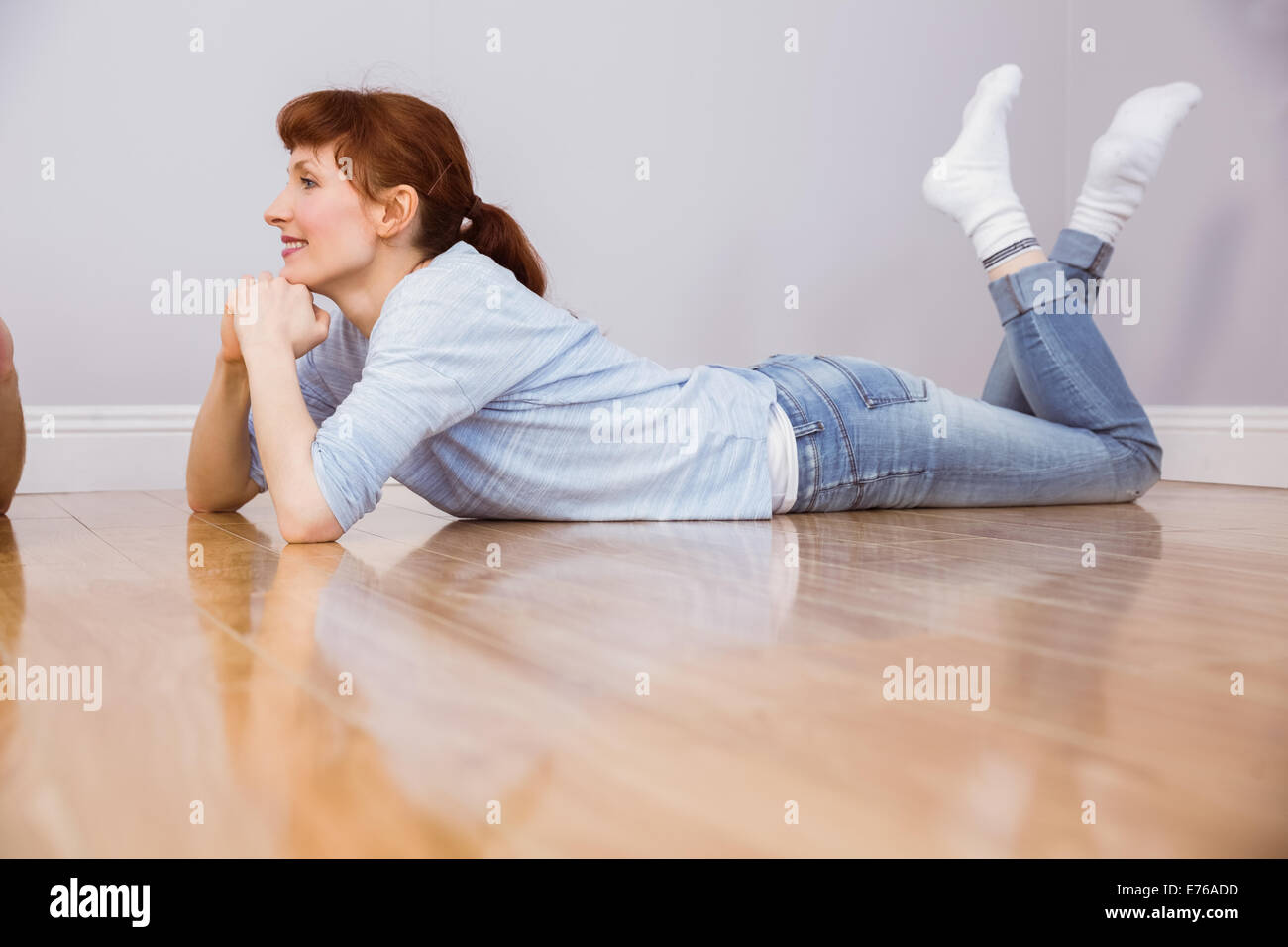Woman lying on the floor Stock Photo - Alamy