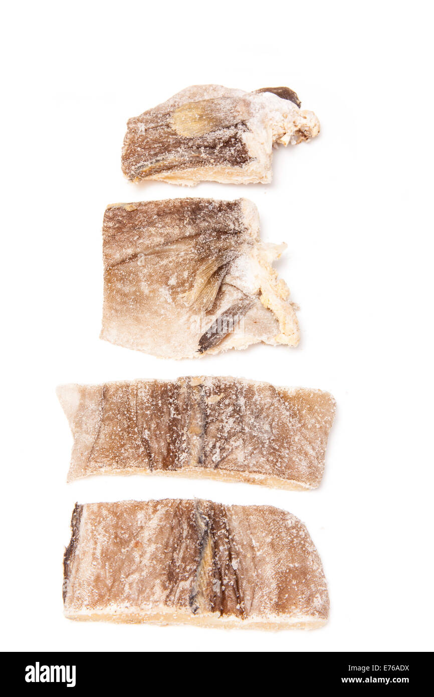 Pieces of salt cod fish isolated on a white studio background Stock ...