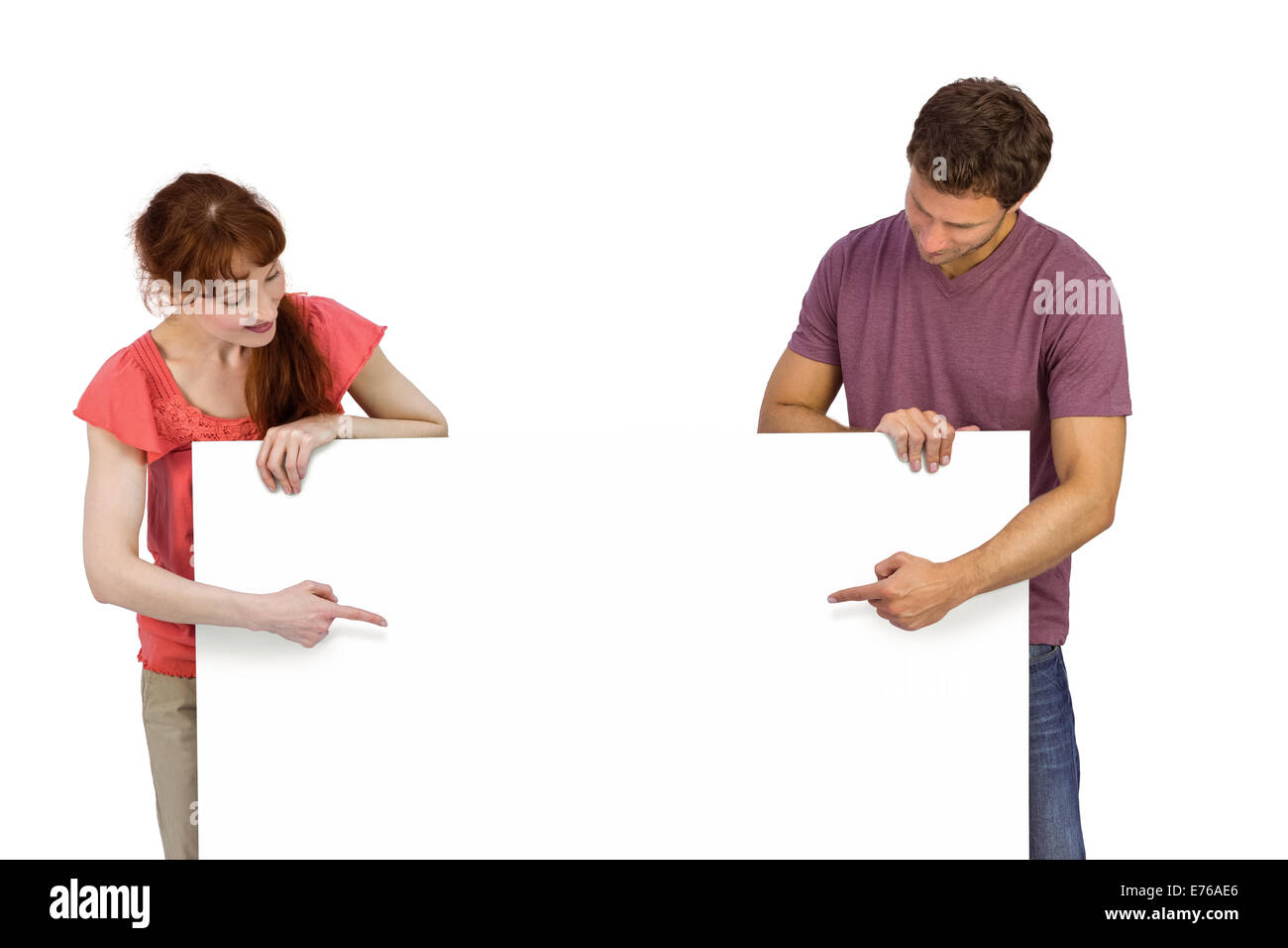 Couple looking at a sign Stock Photo - Alamy