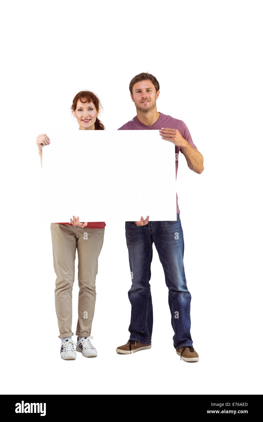 Couple holding a white sign Stock Photo - Alamy