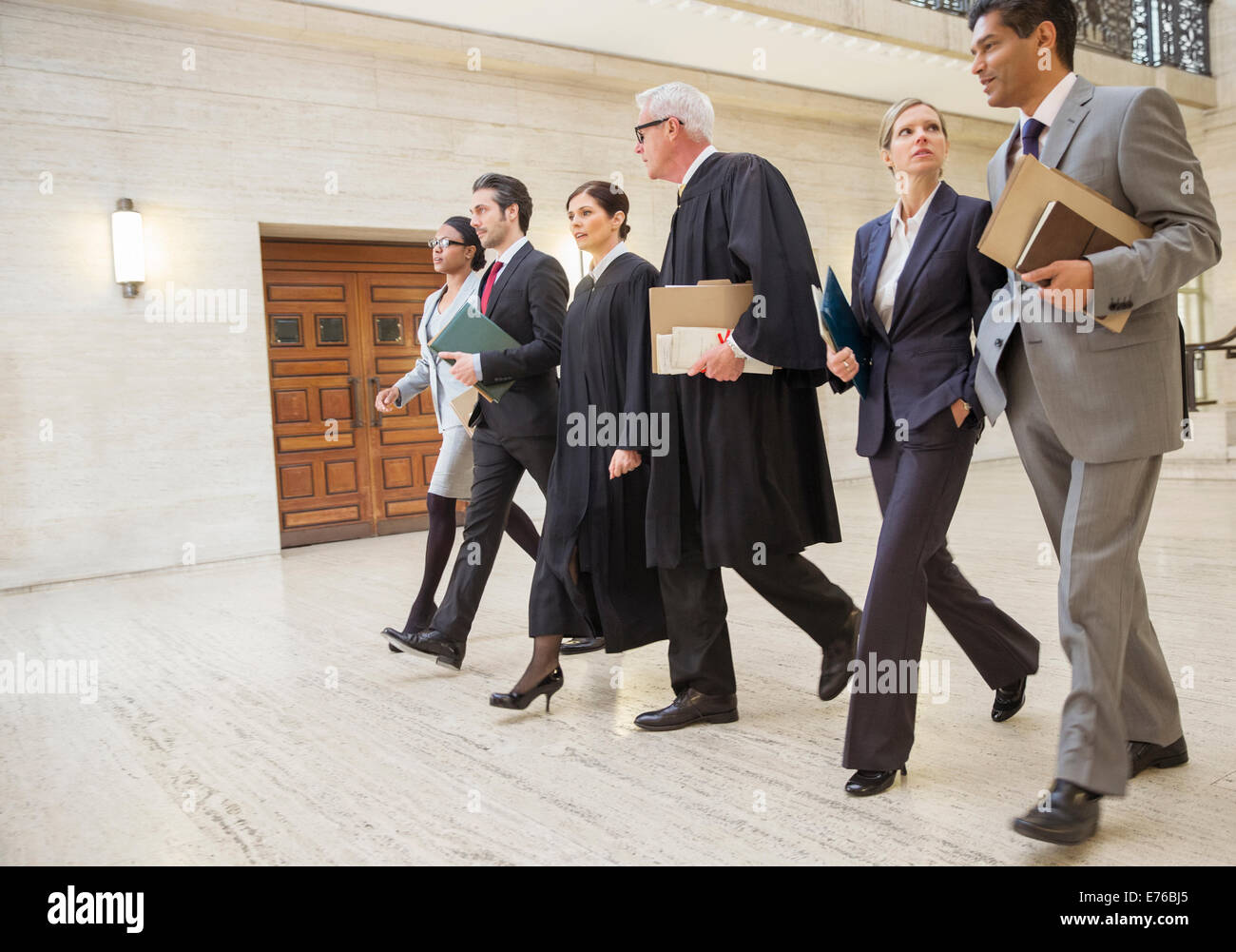 Judges and lawyers walking through courthouse together Stock Photo - Alamy