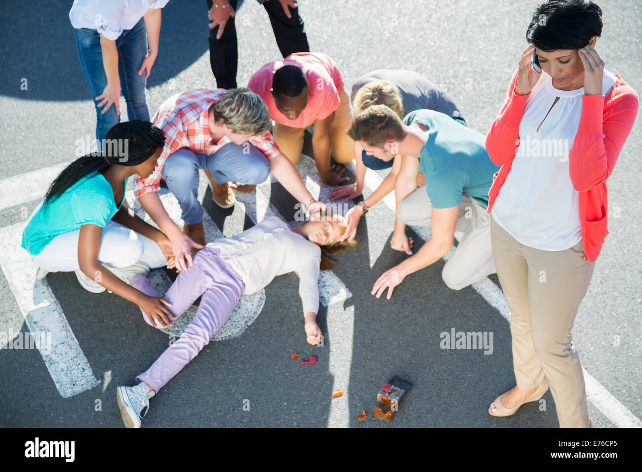 People rushing to injured girl on street Stock Photo - Alamy