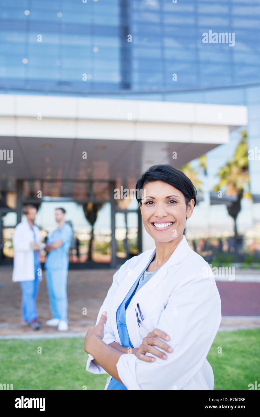 Smiling doctor looking camera arms hi-res stock photography and images ...