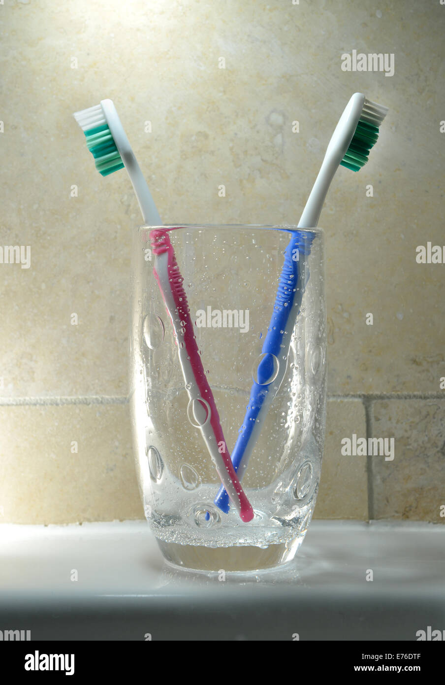 Pink and blue toothbrushes back to back Stock Photo - Alamy