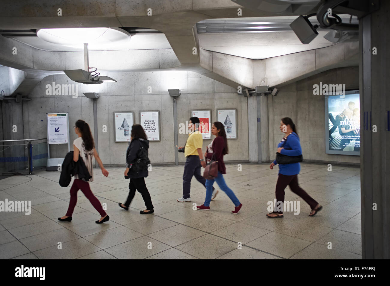 London - Japanese tourists walking past Advertising hoarding or ...
