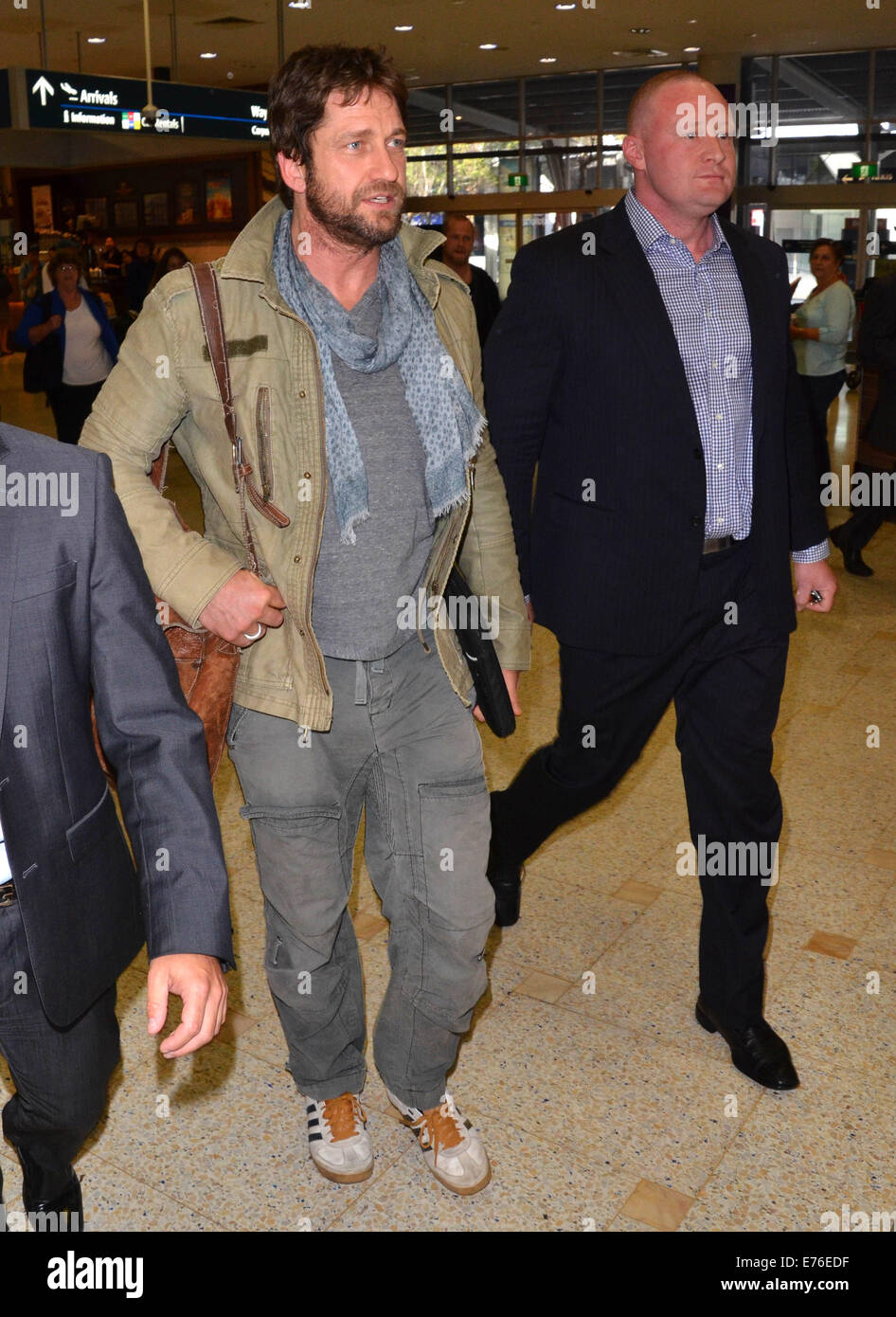 Gerard Butler wearing a light olive green jacket and cargo trousers ...