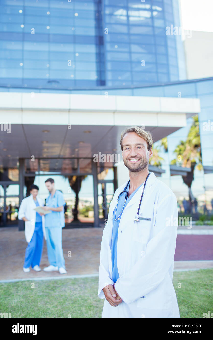 Doctor smiling outside hospital Stock Photo - Alamy