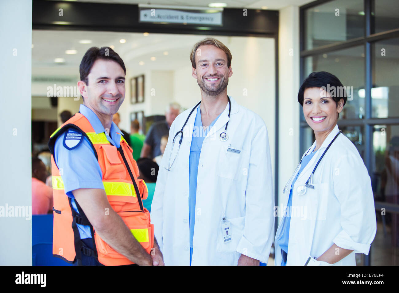Doctors and paramedic smiling outside hospital Stock Photo - Alamy