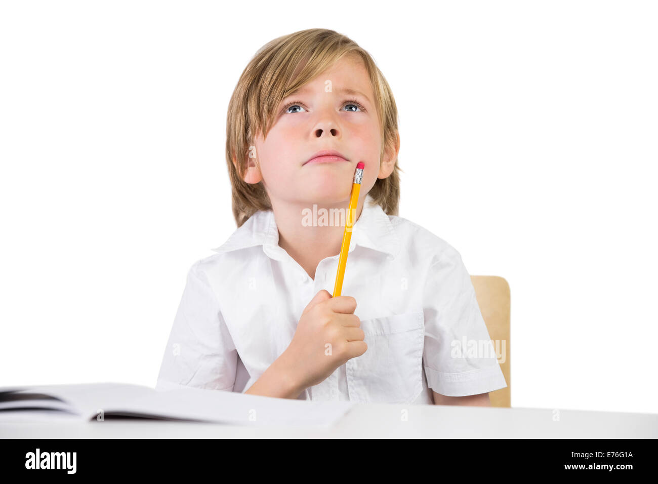 Happy child writing down homework Stock Photo - Alamy