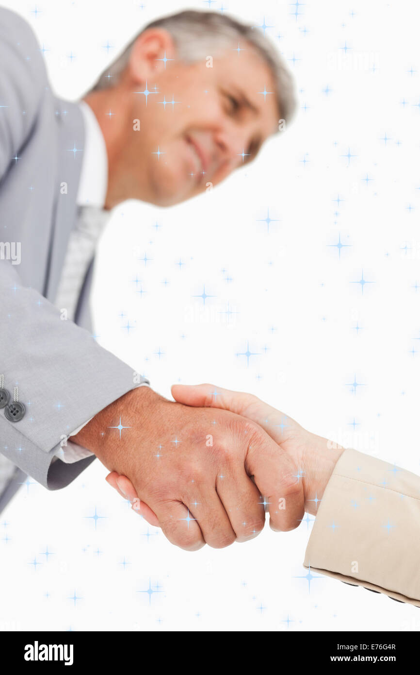 Composite image of low angleshot of a hand shake Stock Photo - Alamy