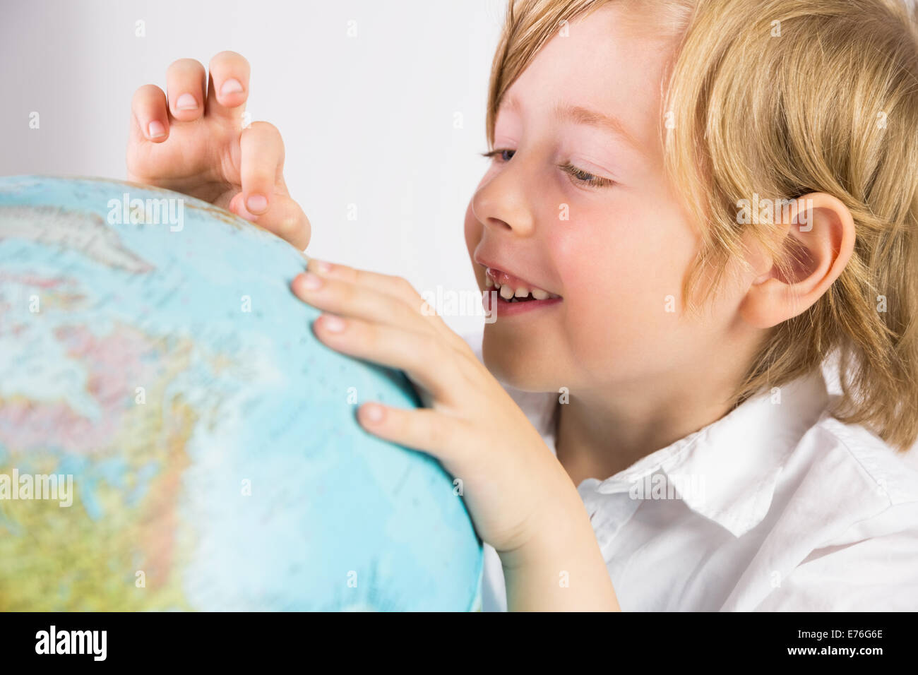 Student learning geography with globe Stock Photo - Alamy