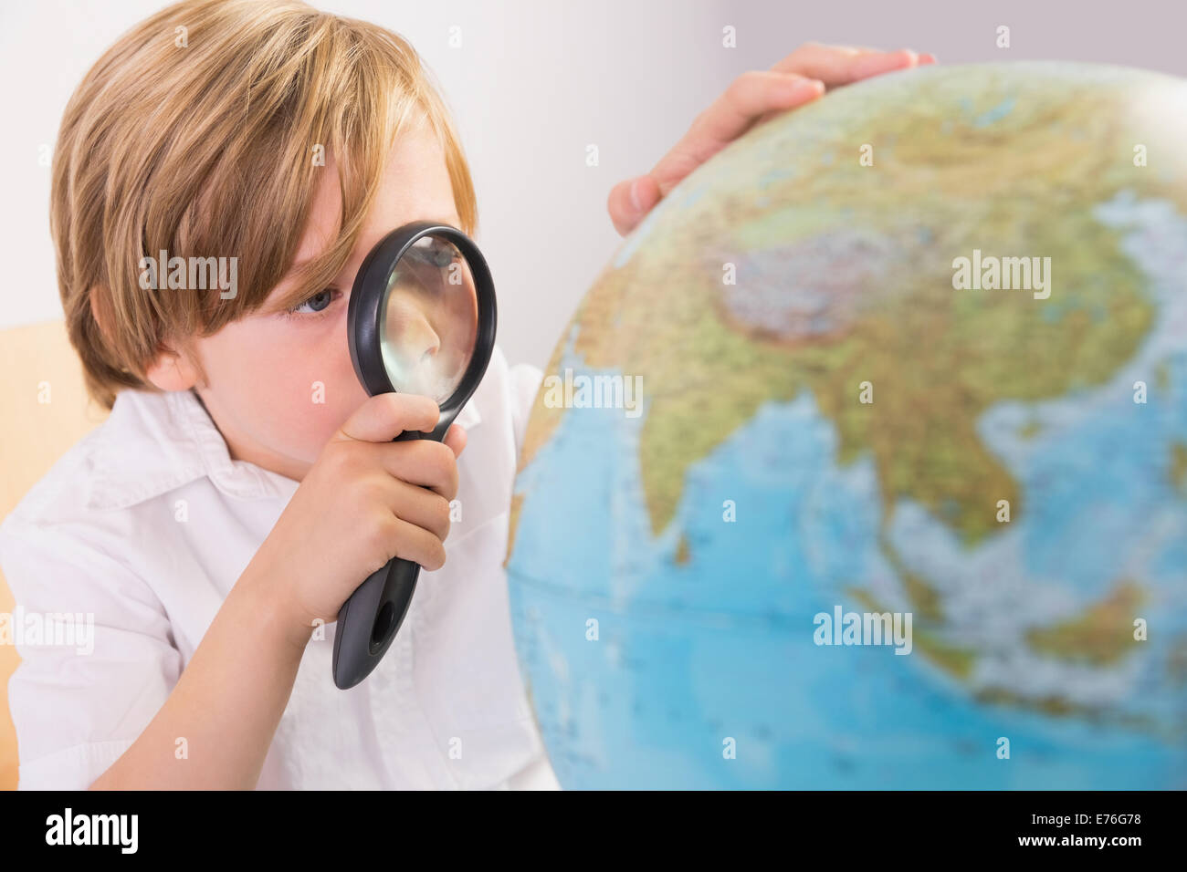 Student learning geography with globe Stock Photo - Alamy