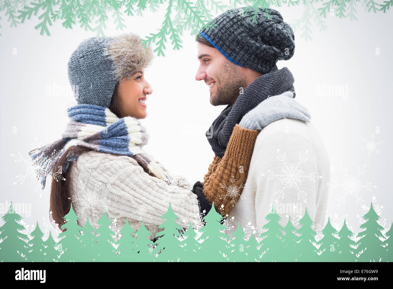 Composite image of attractive young couple in warm clothes hugging ...