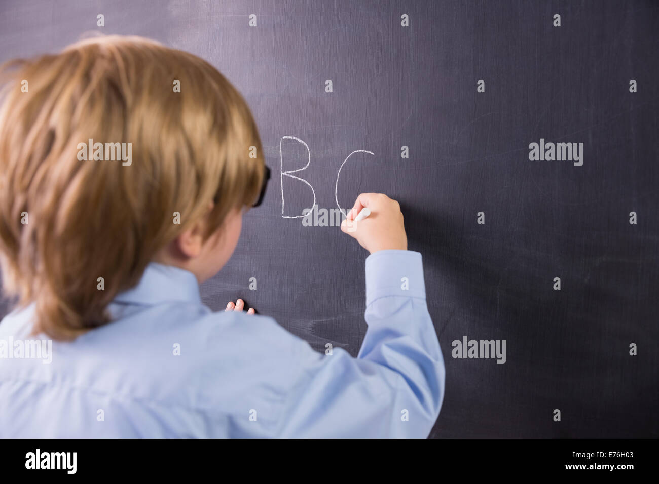Student writing on large blackboard hi-res stock photography and images ...